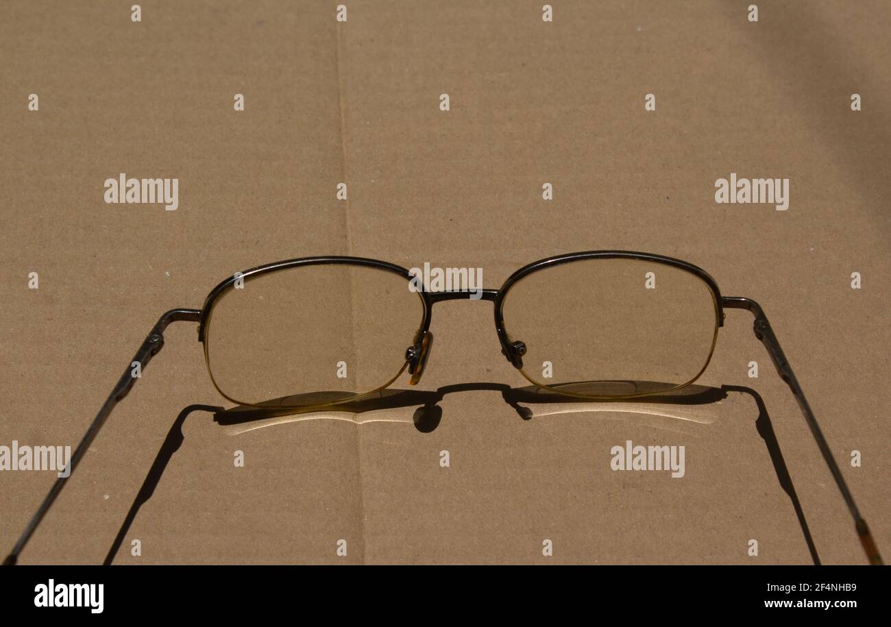 Back view of the eyeglasses lens in a metal frame on the cardboard ...