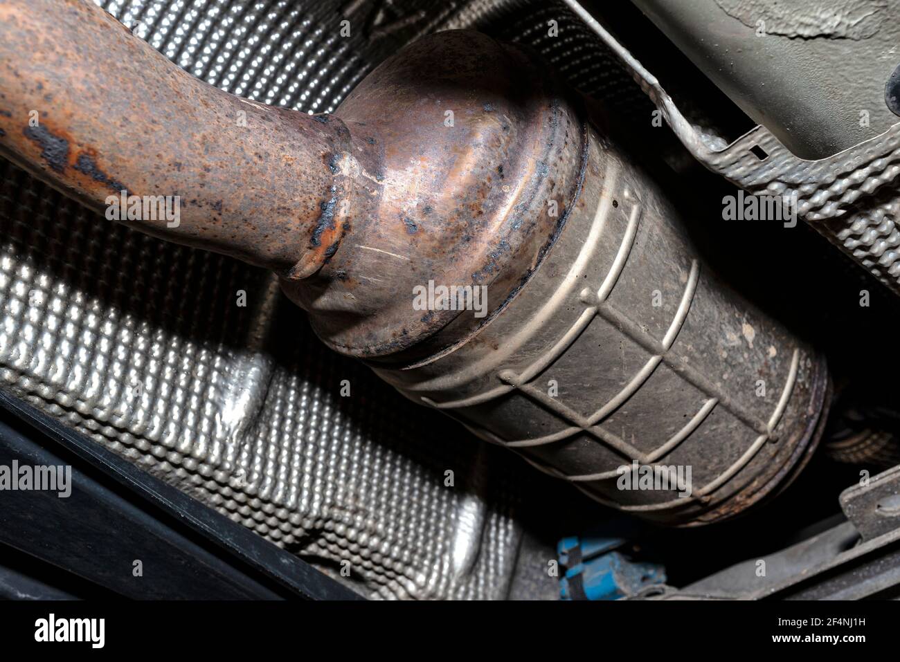A diesel particulate filter in the exhaust system in a car on a lift in ...