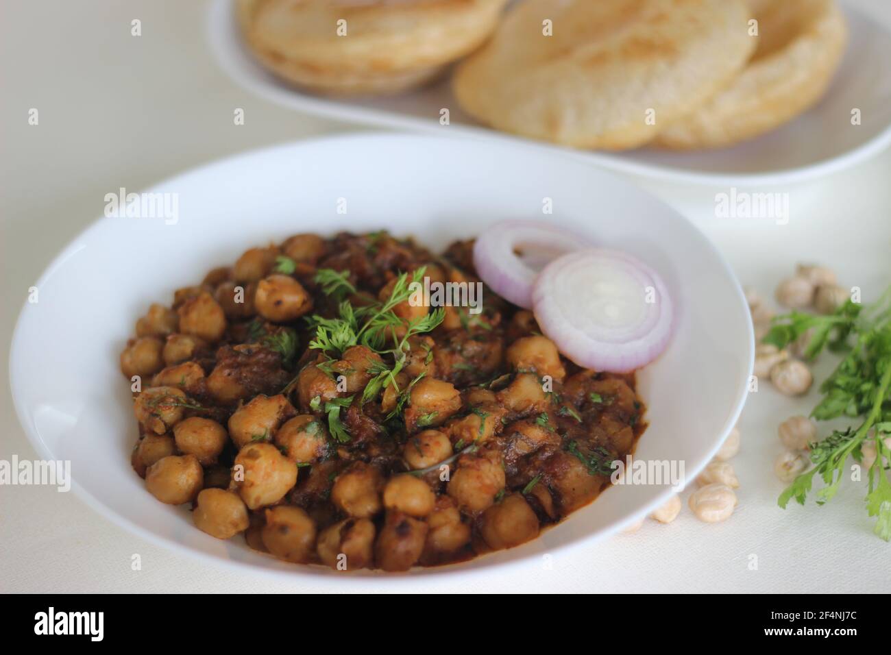 Spicy chickpea gravy with fried Indian flat bread. Locally known as ...