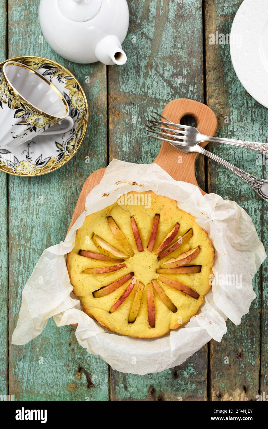 Tea time. Homemade tasty round cake with apples freshly baked in paper ...
