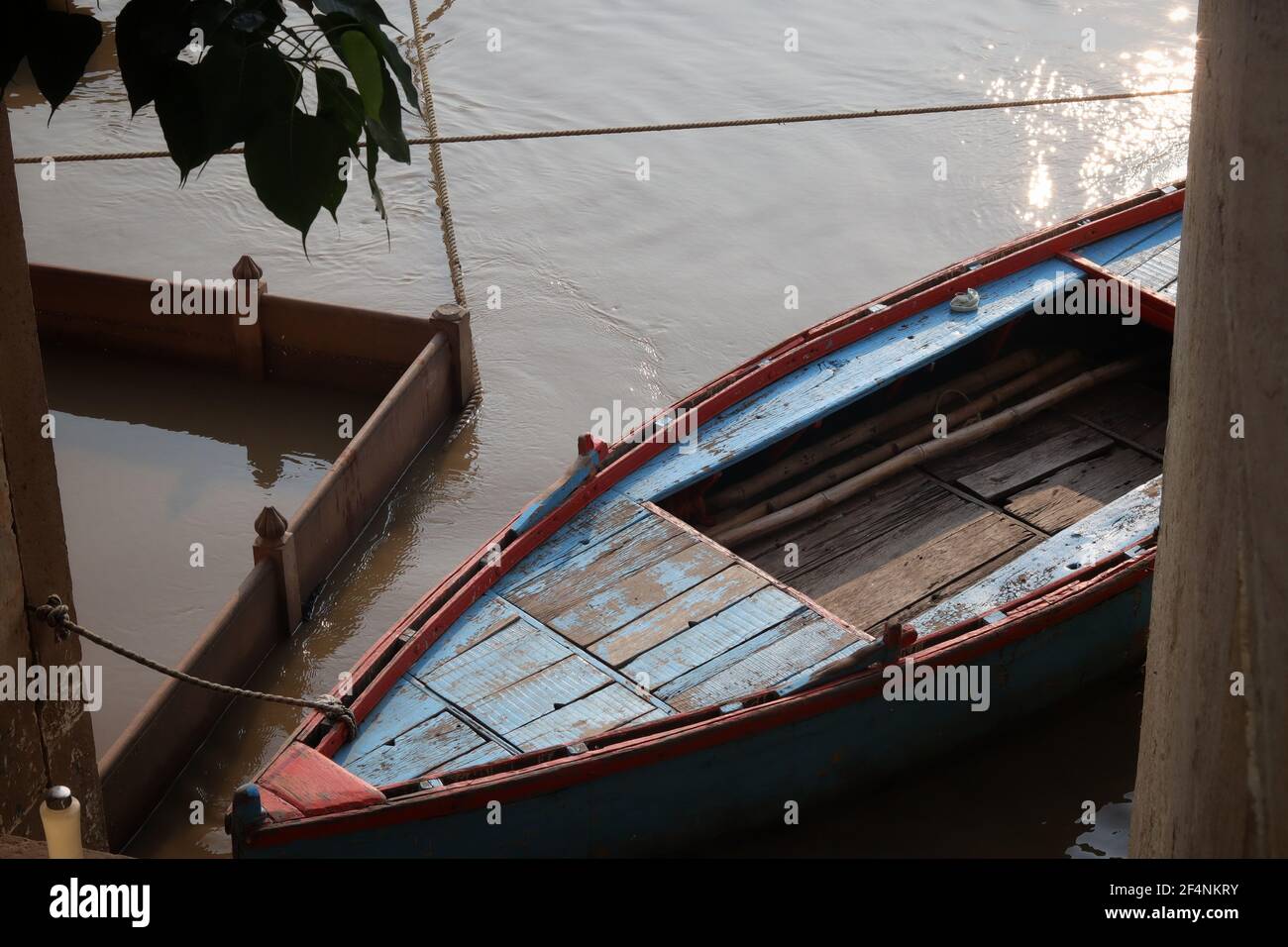 High angle shot of an empty wooden boat parked near a pier in a lake ...