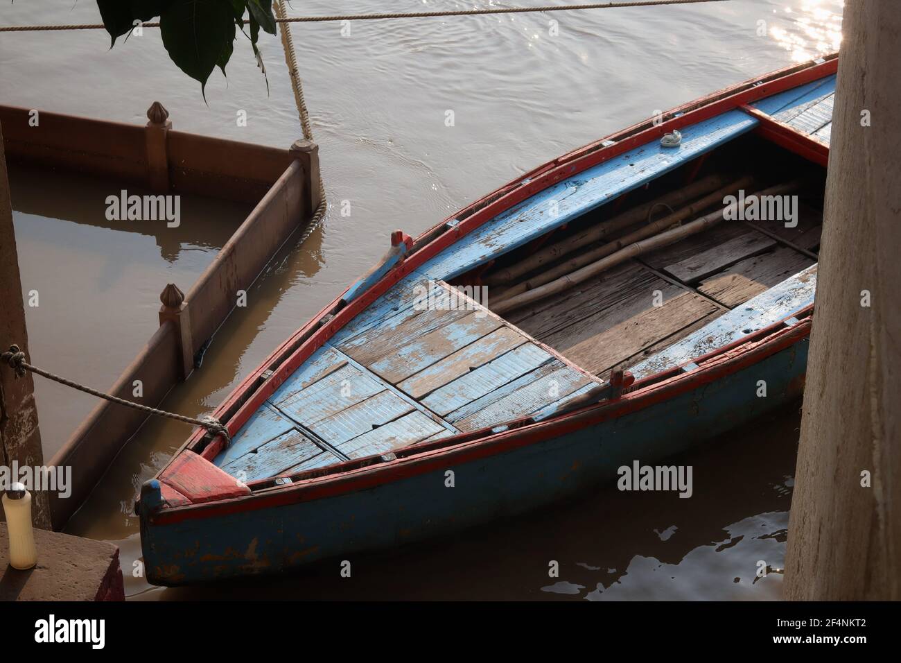 High angle shot of an empty wooden boat parked near a pier in a lake ...