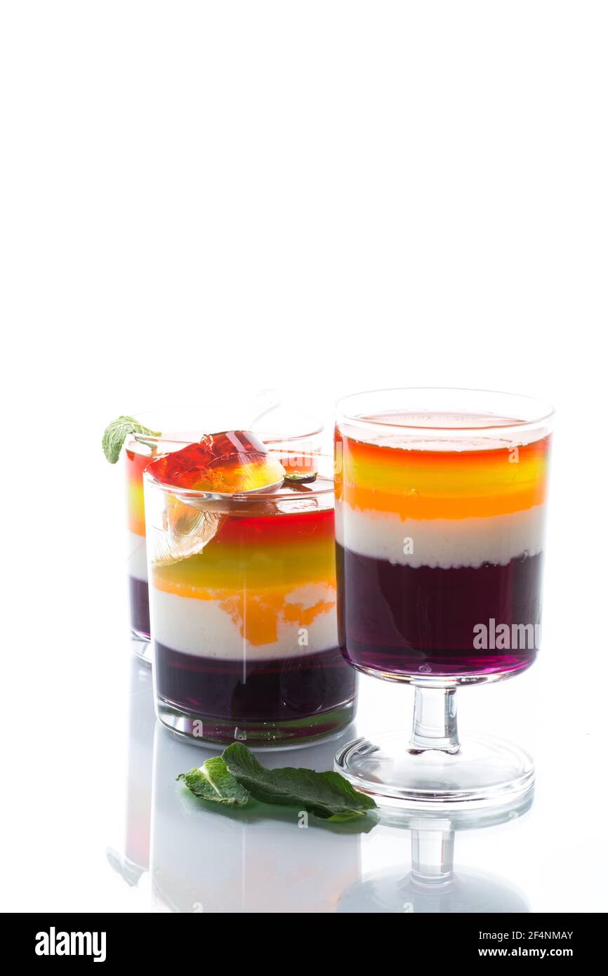 lot of colored sweet fruit jelly in a glass isolated on white ...