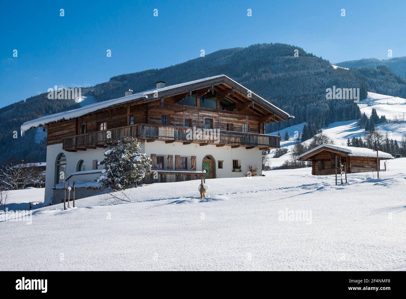 Austrian traditional tyrolean family house in the snow. Alpine home ...