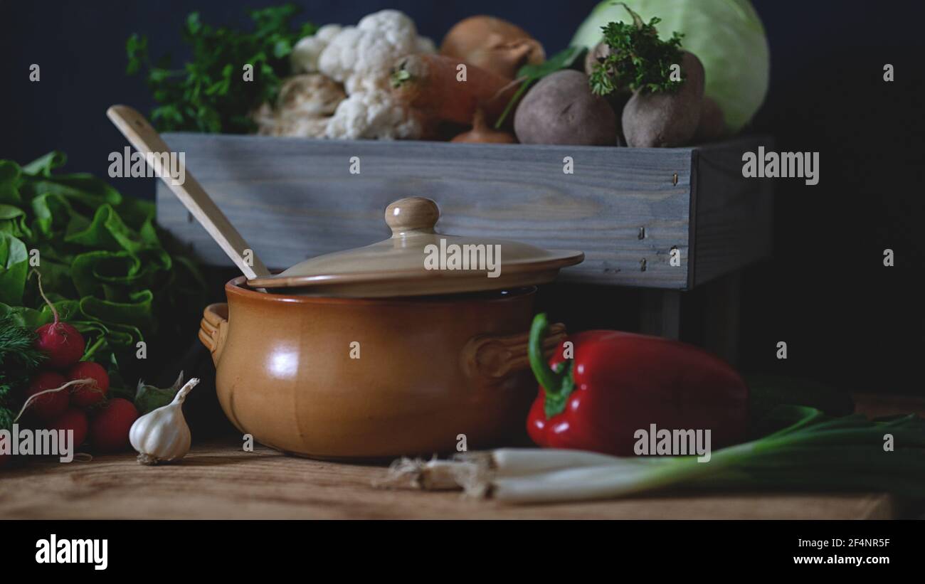 Clay cooking pot next to fresh vegetable .Vegetarian home cooking ...