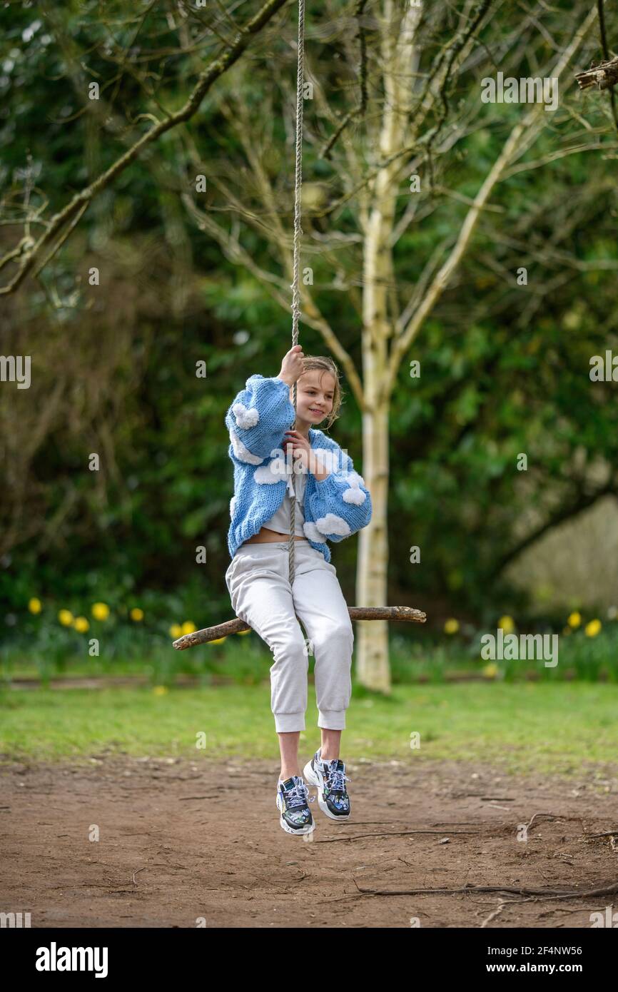 Girl on a stick swing Stock Photo - Alamy