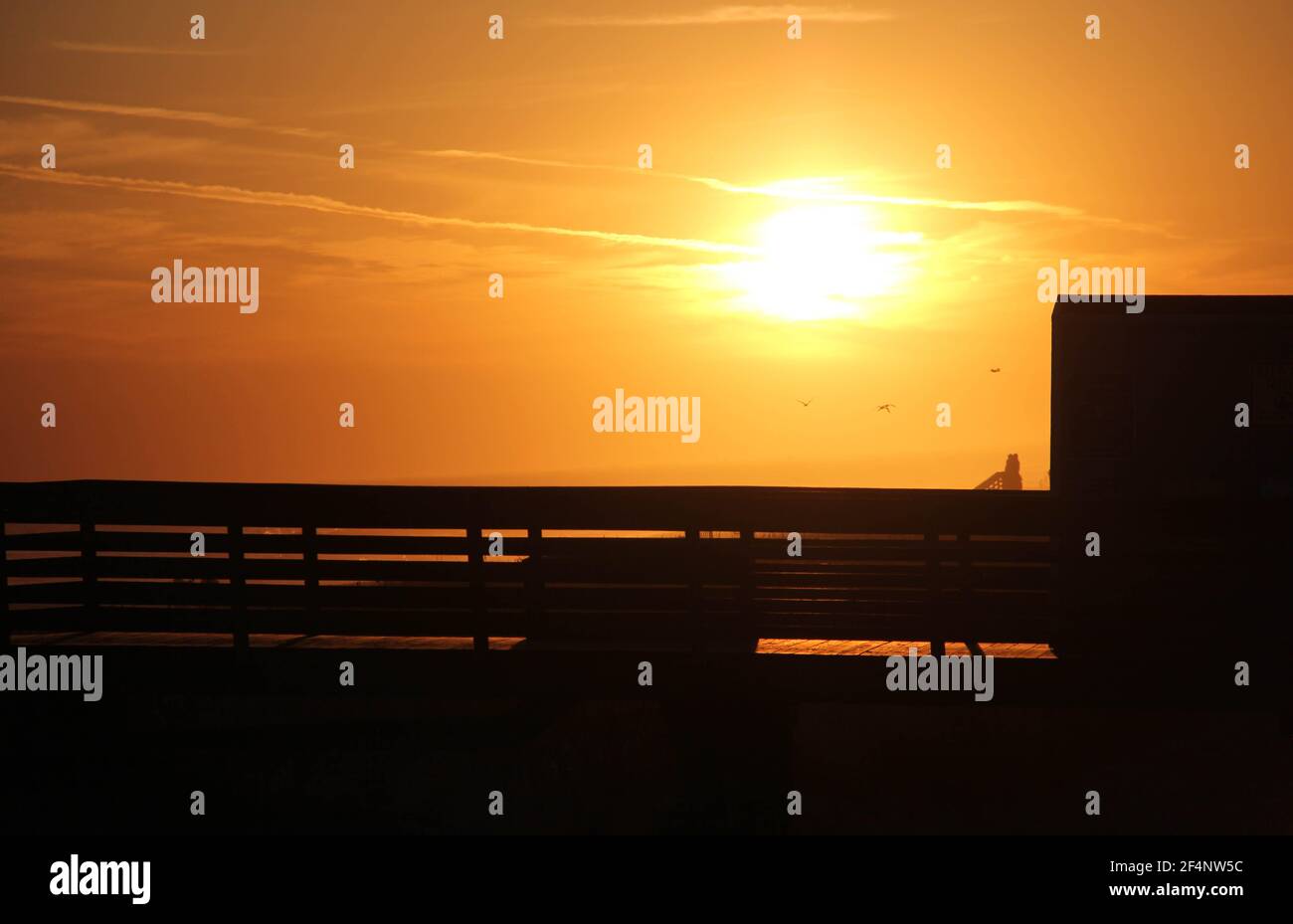Hazy Sunset over Boardwalk Stock Photo - Alamy