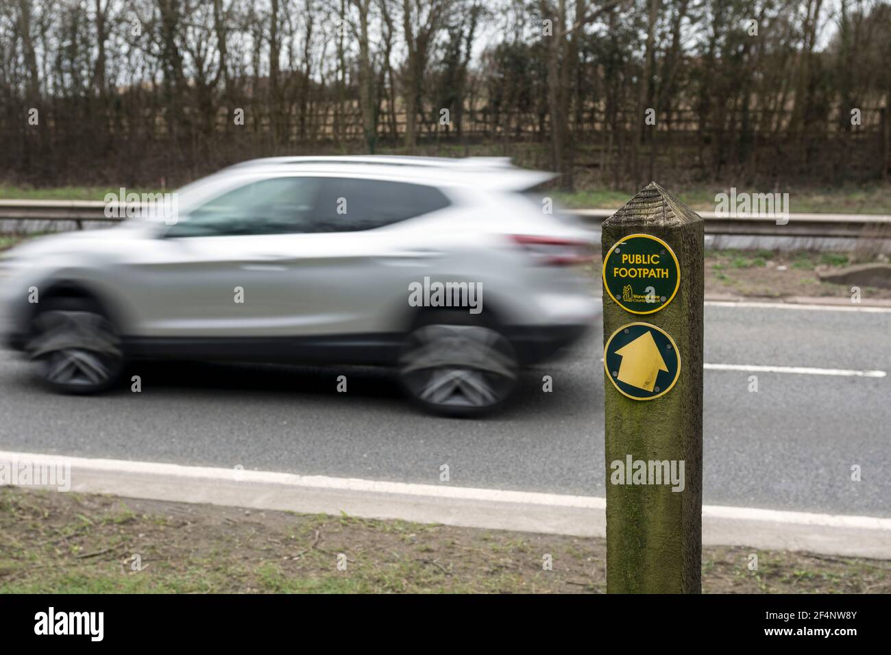 Public footpath sign where the path crosses the A46 road, Hampton Magna ...
