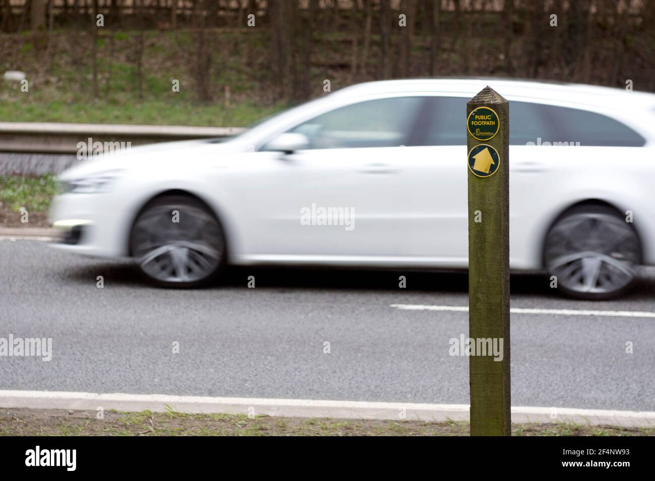 Public footpath sign where the path crosses the A46 road, Hampton Magna ...