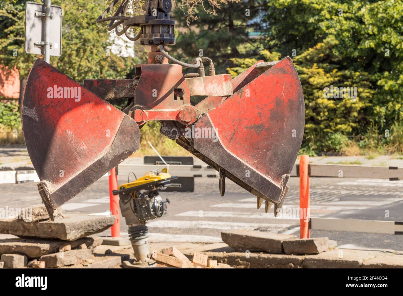street renovation works using a small grab excavator Stock Photo - Alamy