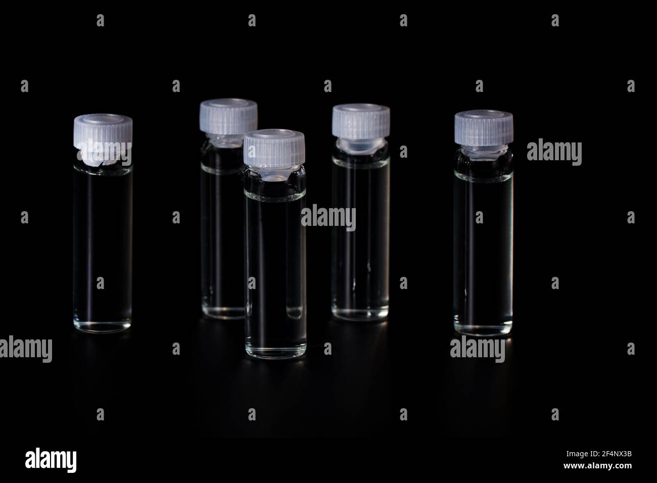 Cosmetic bottles with natural medicine, essential oil on black ...