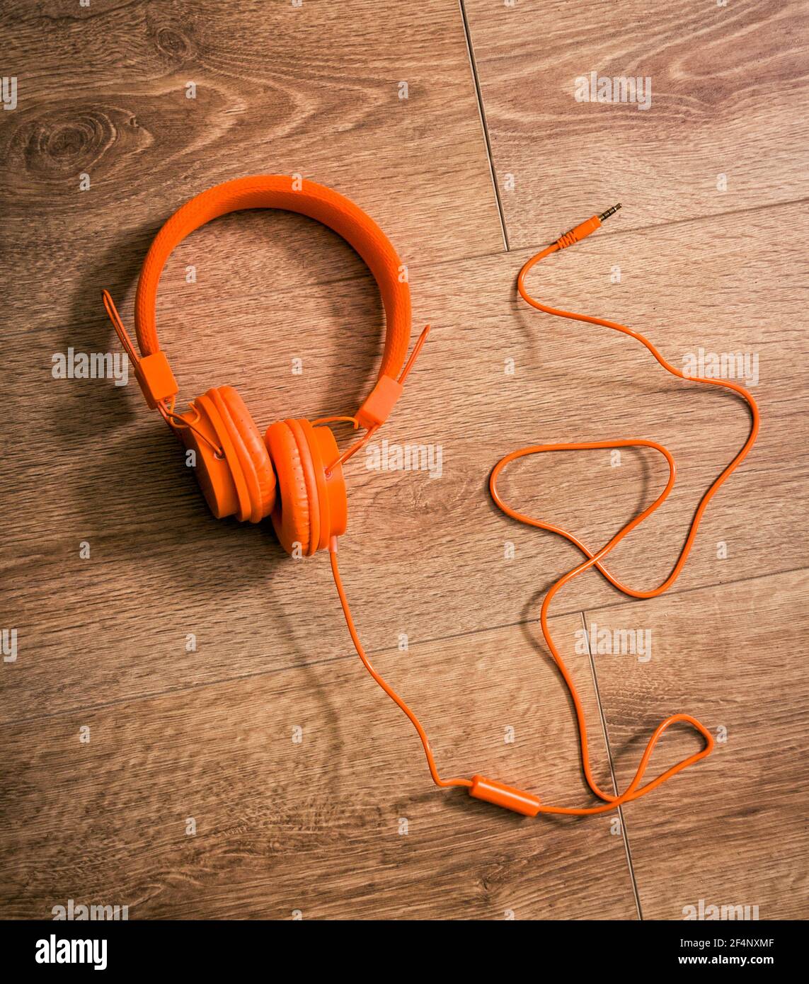 Modern orange headset headphones on the table Stock Photo - Alamy