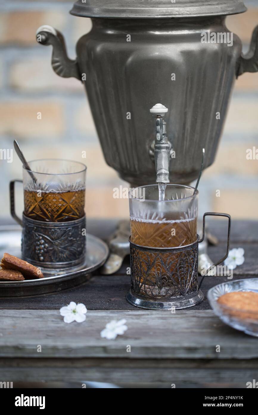 Russian traditional tea-drinking: a samovar, drying and tea in cup ...