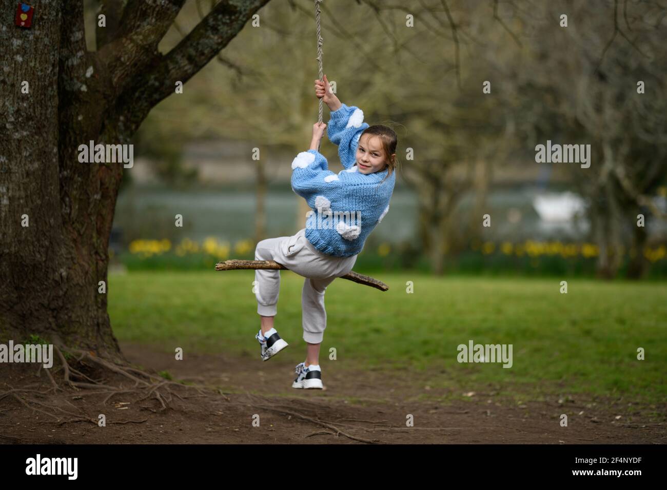 Girl on a stick swing Stock Photo - Alamy