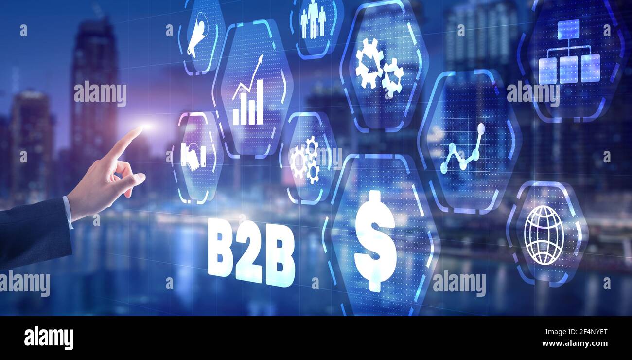 Businessman presses B2B icon on virtual screen on modern city ...