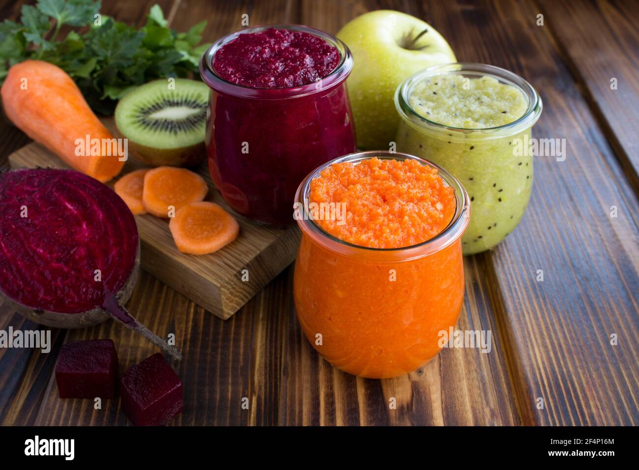 Different vegetable and fruit smoothies or puree in the small glass ...