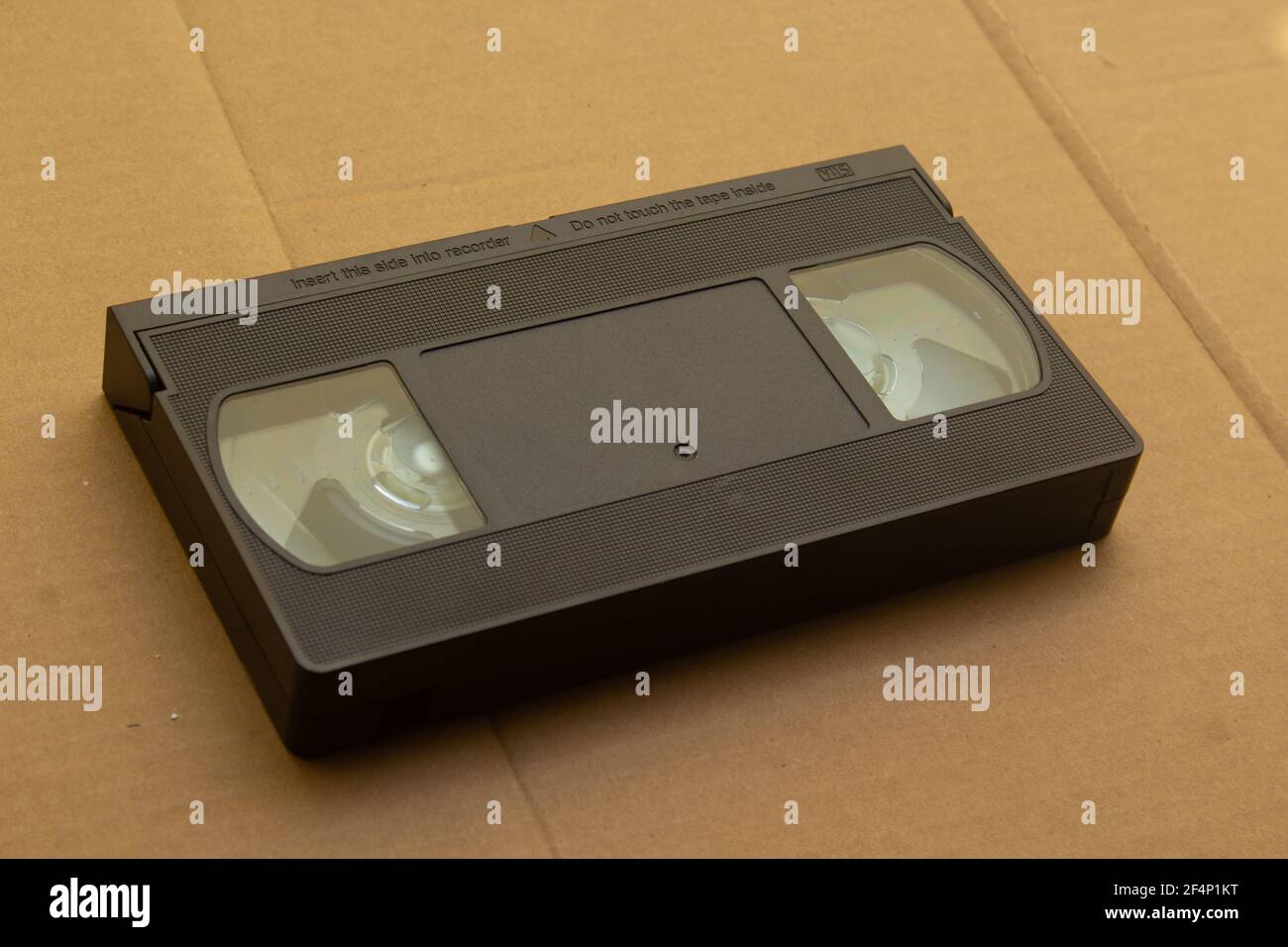 Topside of a VHS cassette tape isolated on a cardboard surface Stock ...