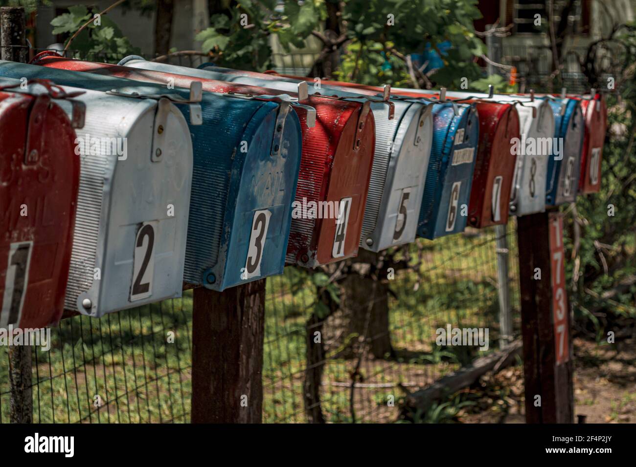 Selective focus shot of colorful (blue, white, and red) mailboxes ...