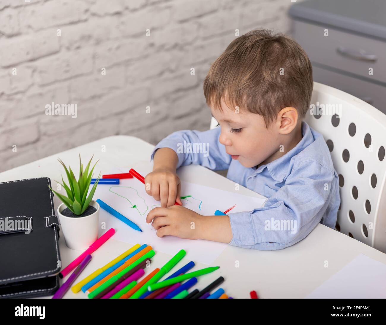 Elementary boy learning at home. Cute cheerful child drawing Stock ...
