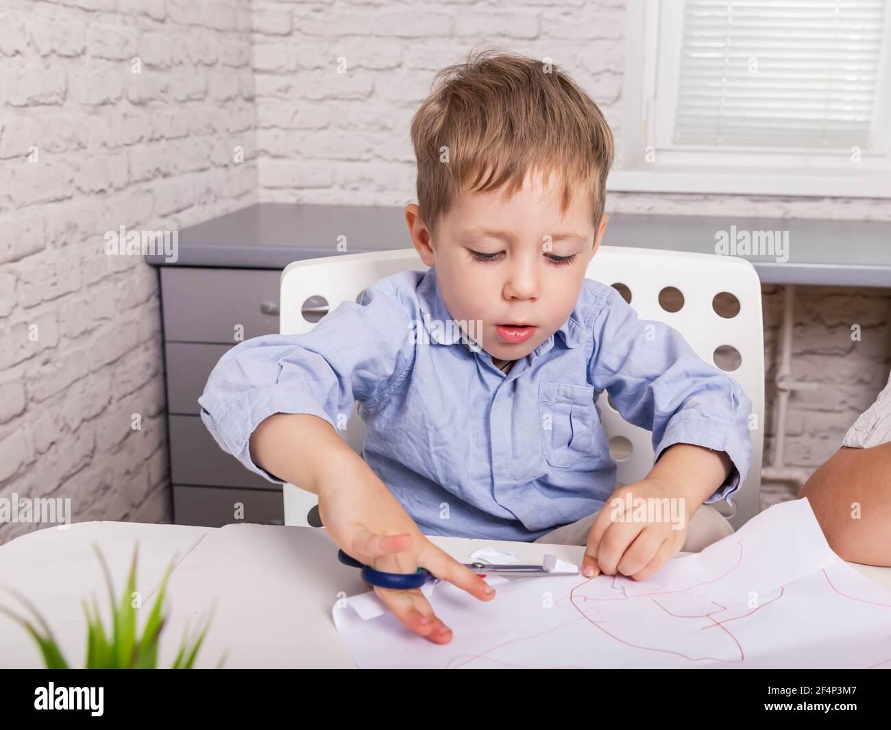 Craft for children. Kid cutting with scissors and gluing paper Stock ...
