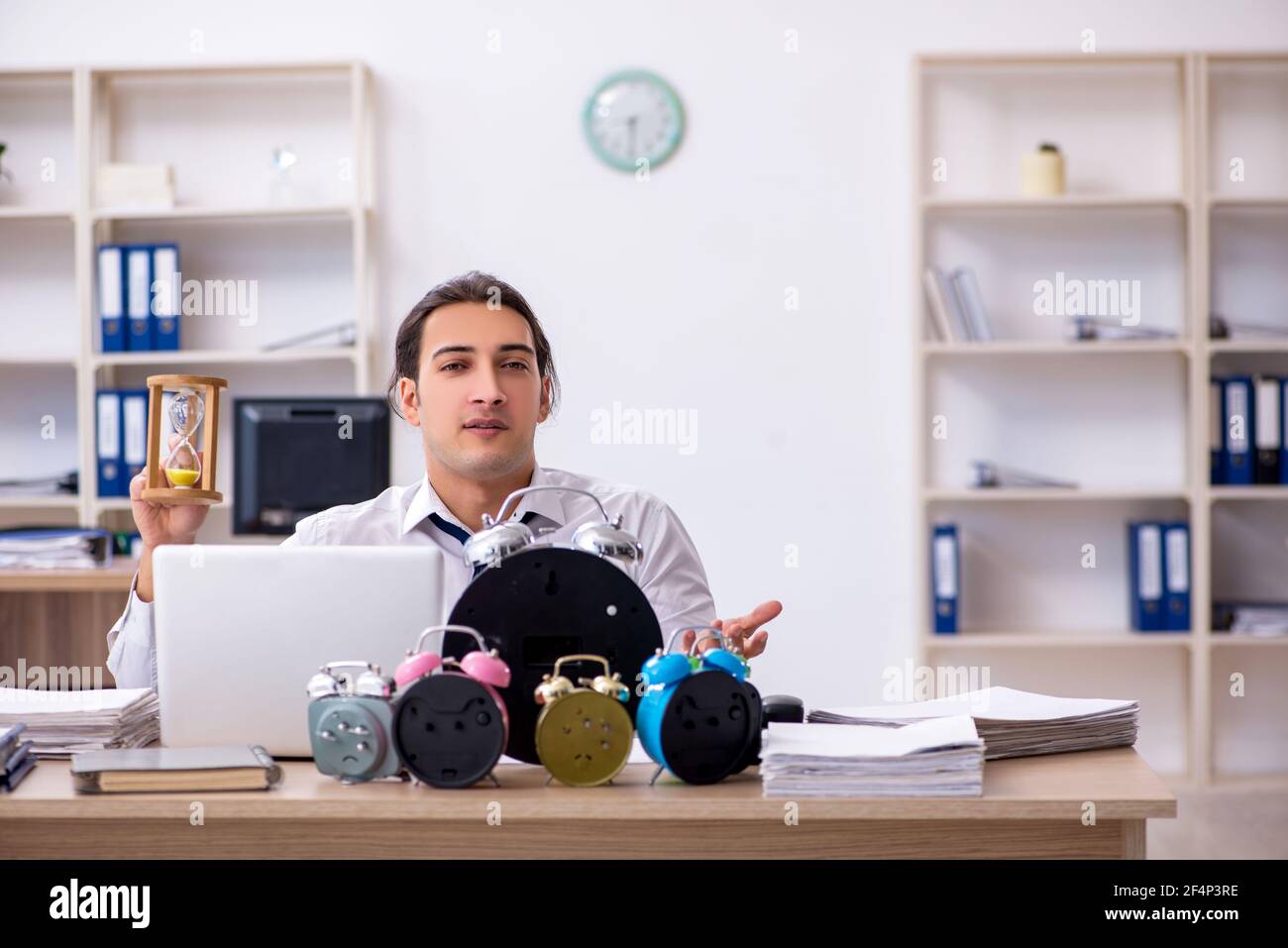 Young employee afraid of missing deadline at workplace Stock Photo - Alamy
