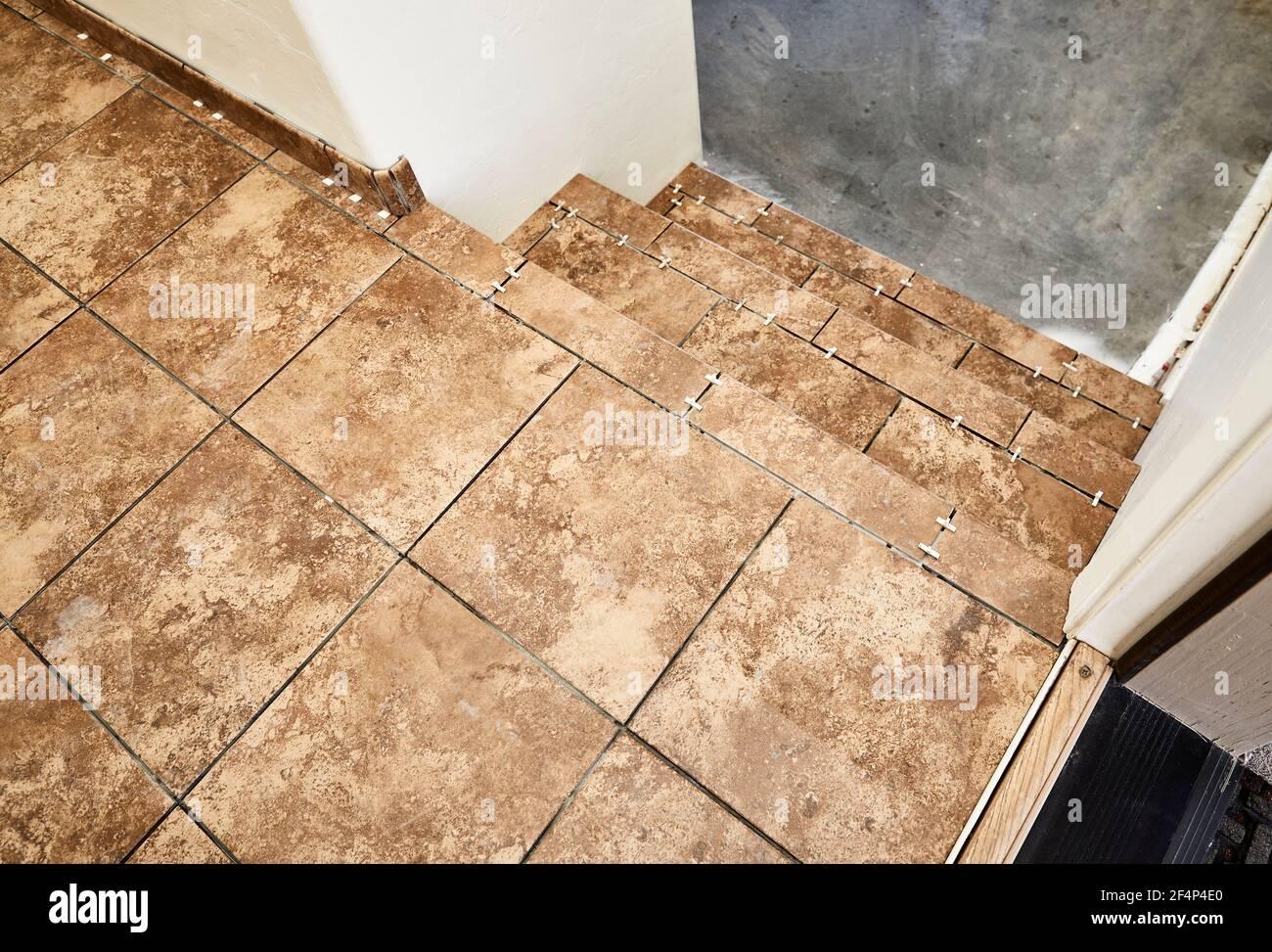 New tile installation on steps with a landing in preparation to be ...