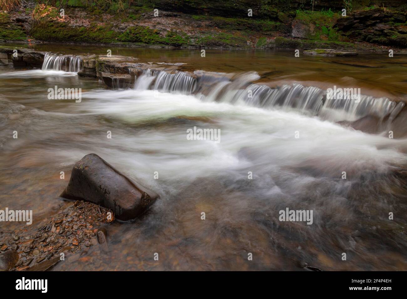 The weir on The Upper Clydach River which runs through the town of ...