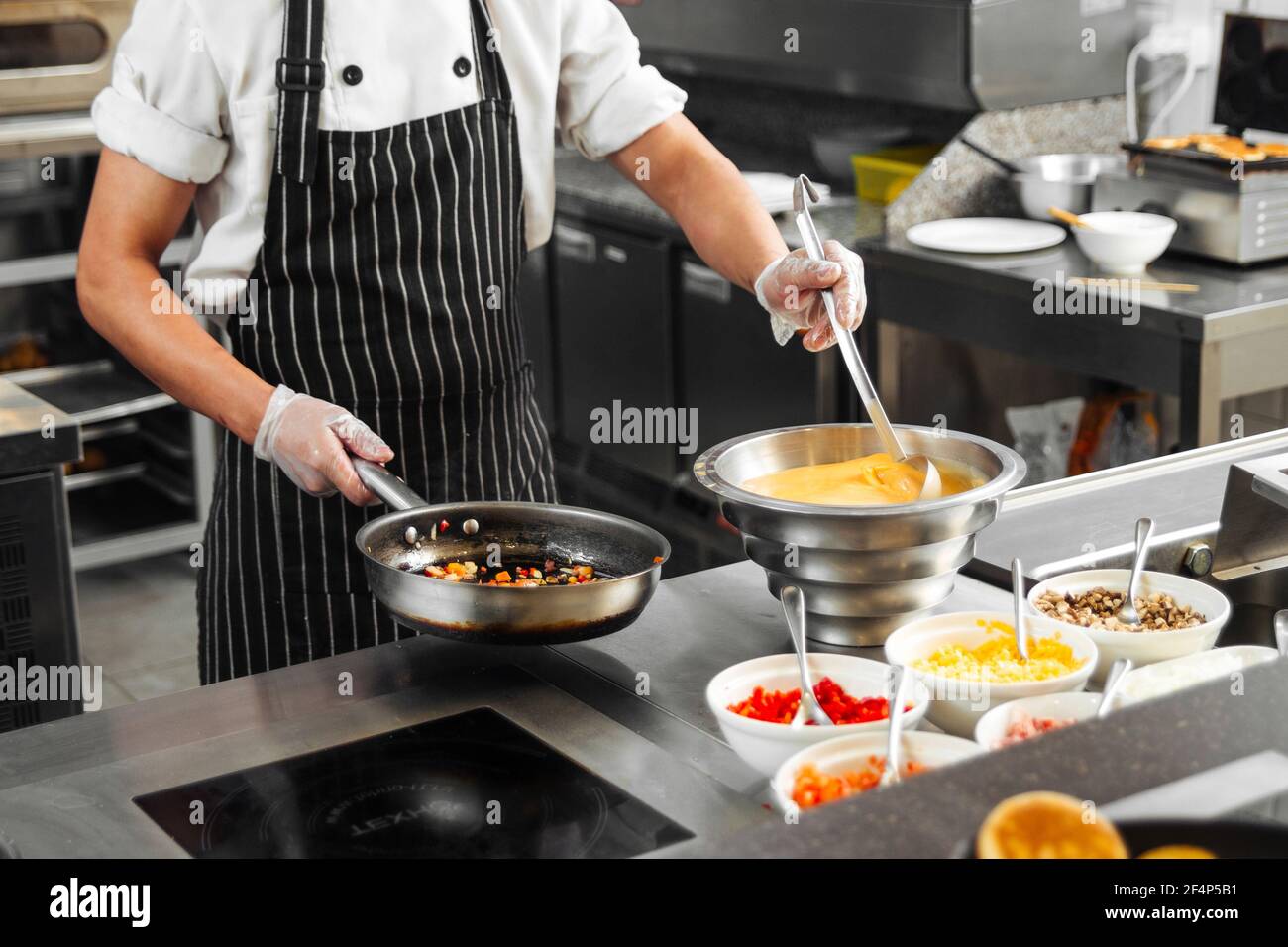 Restaurant cooks preparing food in the kitchen Stock Photo - Alamy