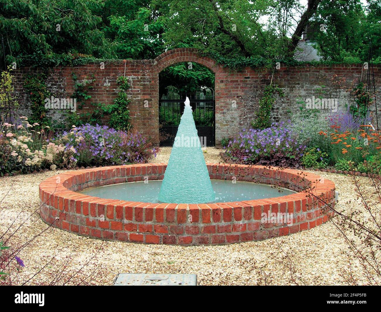 Glass cone garden water feature Stock Photo - Alamy
