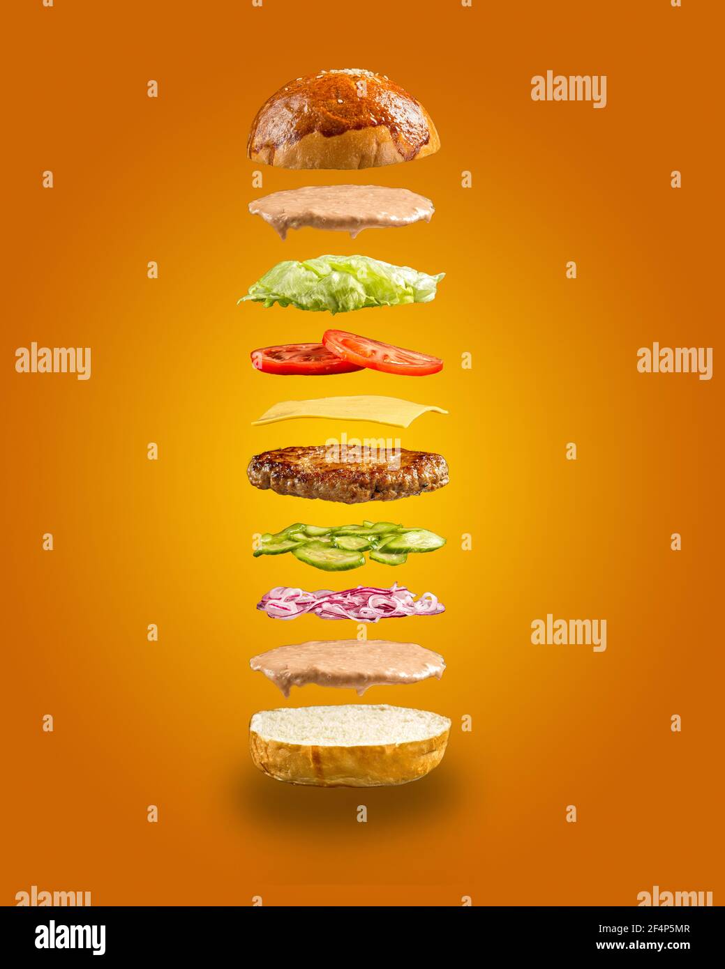 Floating burger ingredients on the yellow background Stock Photo - Alamy