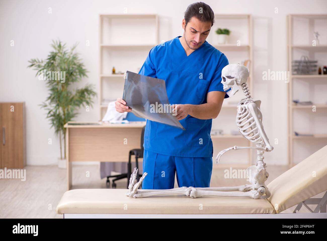 Young doctor radiologist and skeleton patient in the clinic Stock Photo ...