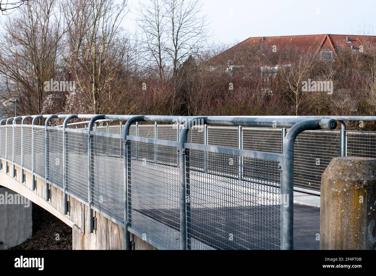 a bannister of a footbridge over a street with metal grid Stock Photo ...