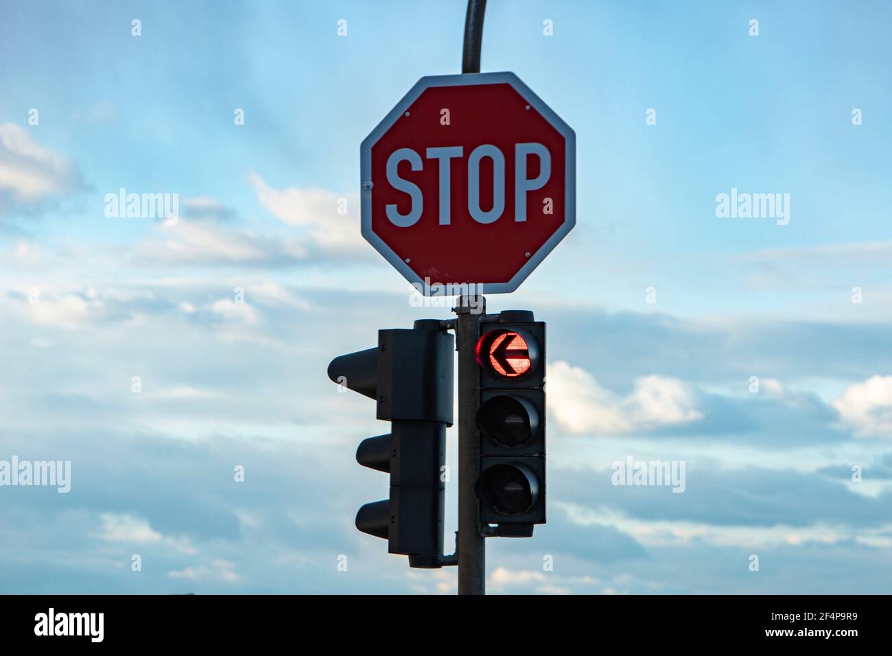 German stop sign and a traffic light showing red, arrow to the left ...
