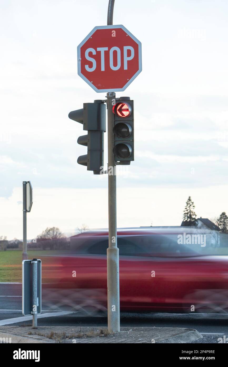 German stop sign and a traffic light showing red, arrow to the left ...