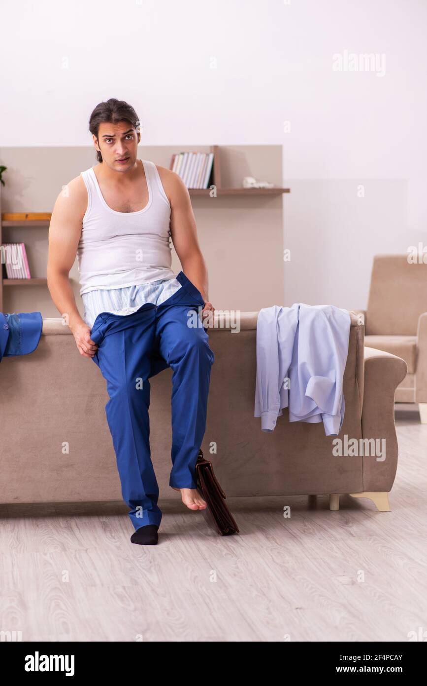 Young employee getting up late at home Stock Photo - Alamy