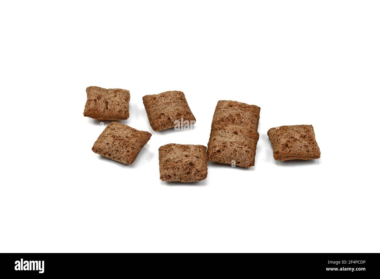 Heap of chocolate pillow cereals isolated on white background. Nougat ...