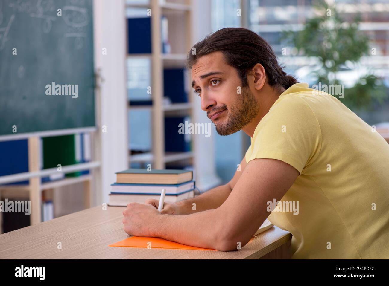 Male student sitting in the classroom Stock Photo - Alamy