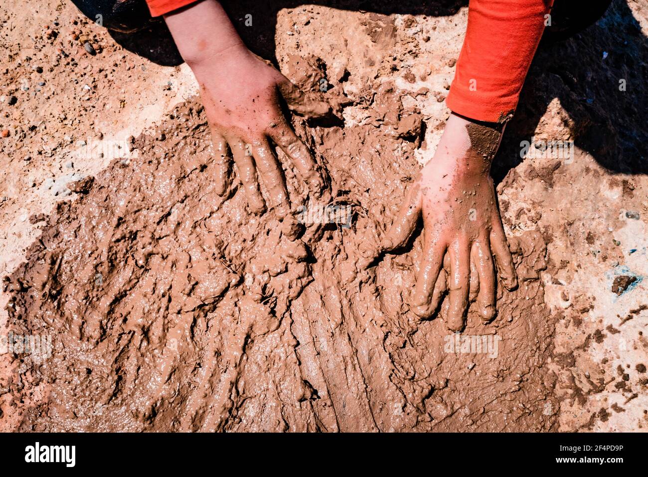 Children's hands in the wet and dirty mud Stock Photo - Alamy