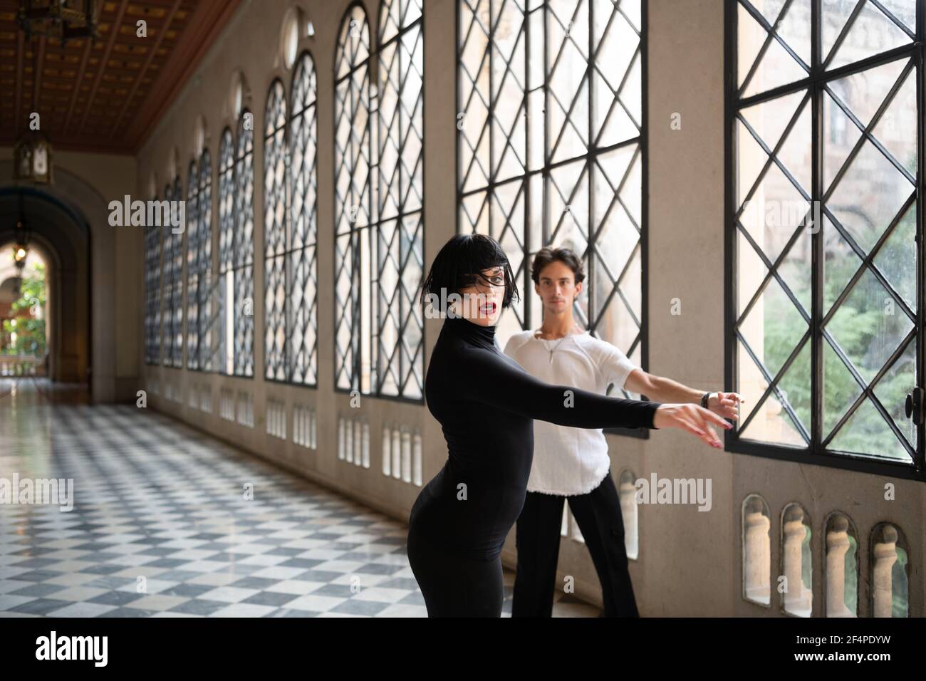 Graceful woman dancing with man in elegant corridor Stock Photo - Alamy
