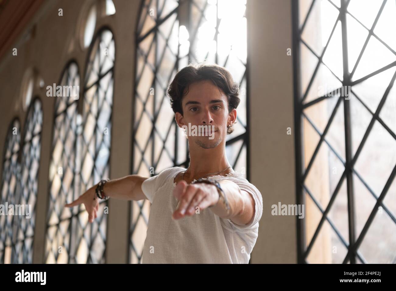 Male dancer spinning around against window Stock Photo - Alamy