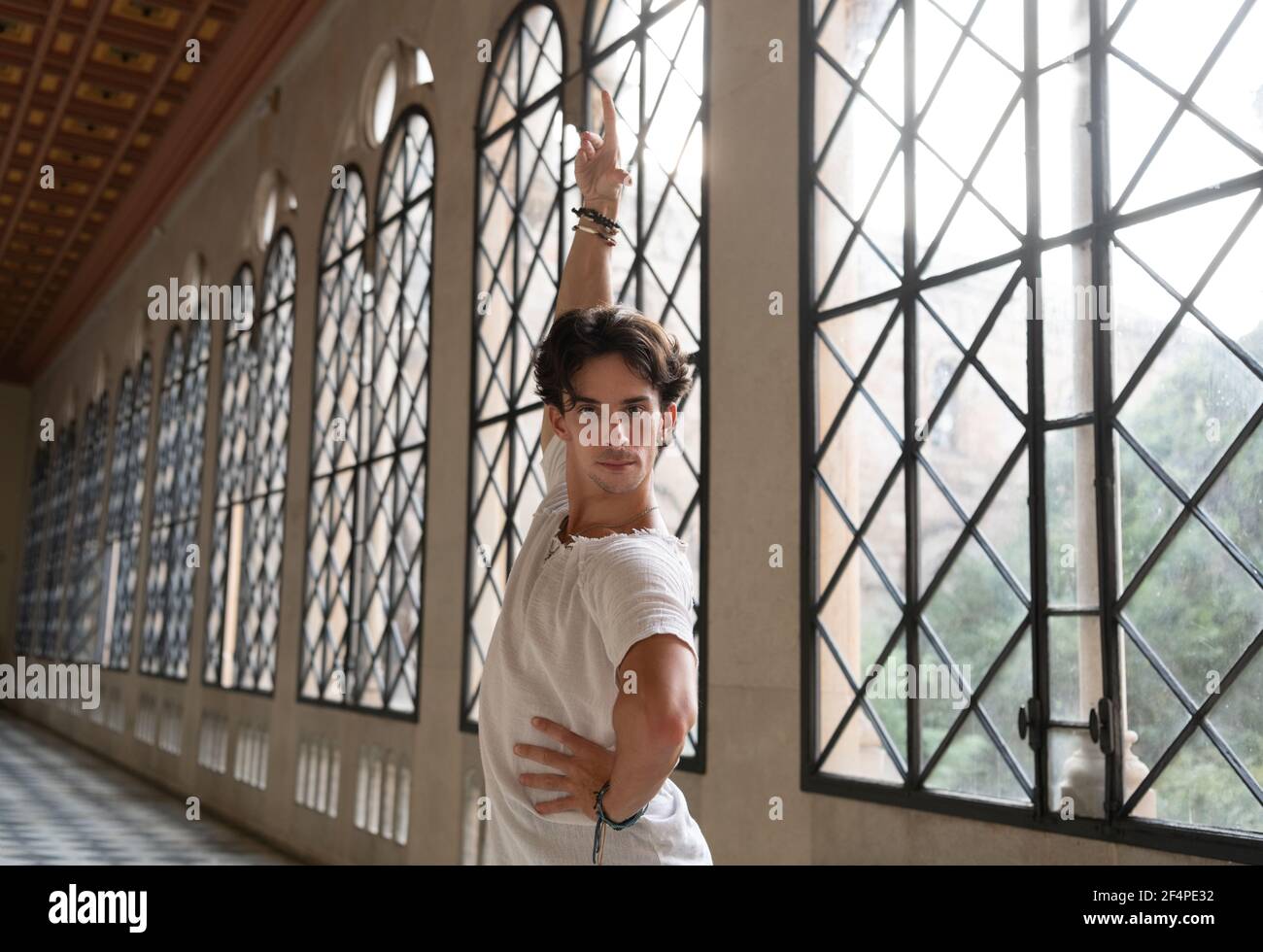 Male dancer with raised arm in ballroom Stock Photo - Alamy