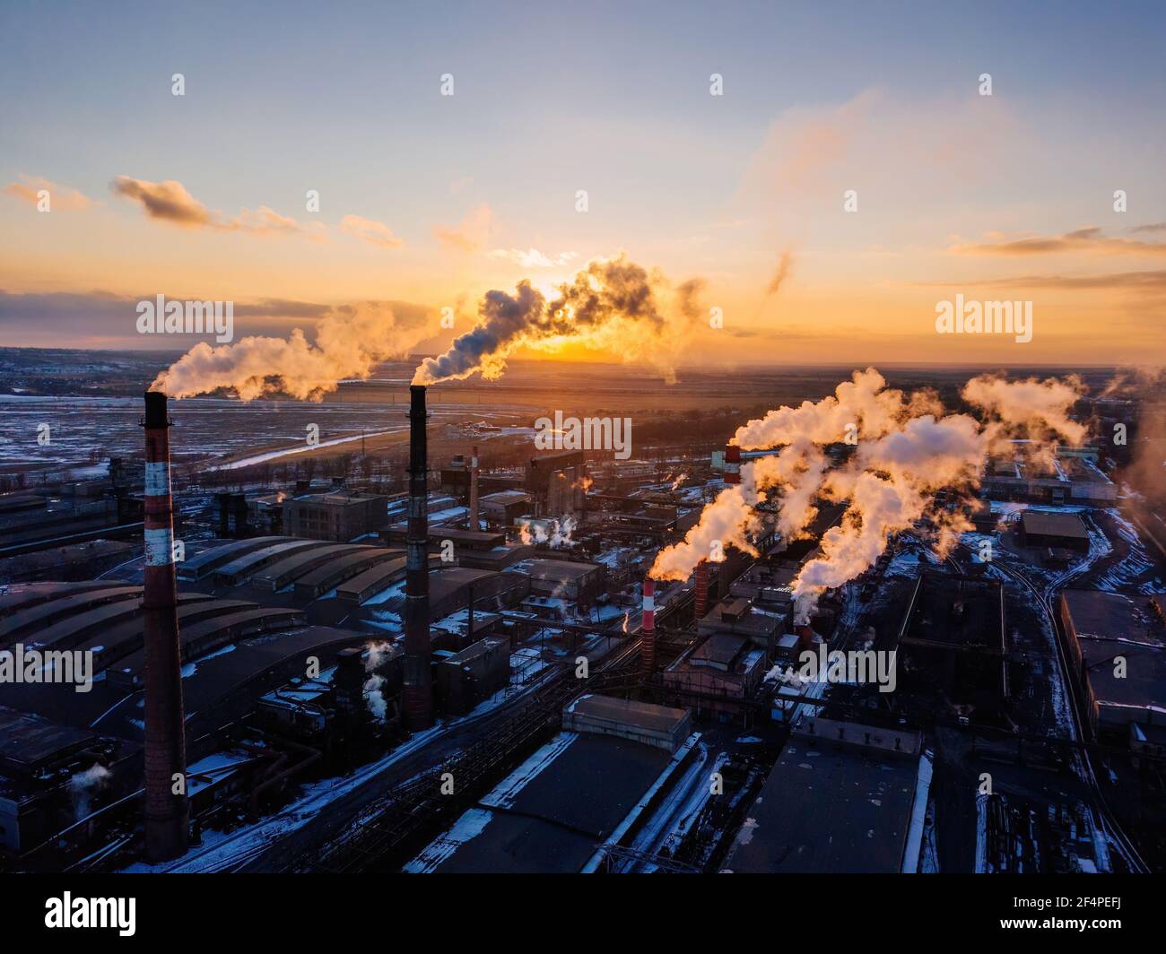 Industrial landscape at the sunset, aerial view. Smoke coming out from ...