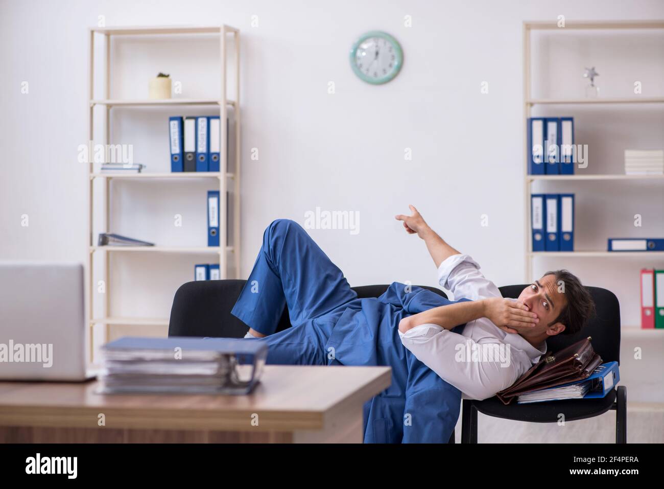 Young employee sleeping in the office on chairs Stock Photo - Alamy
