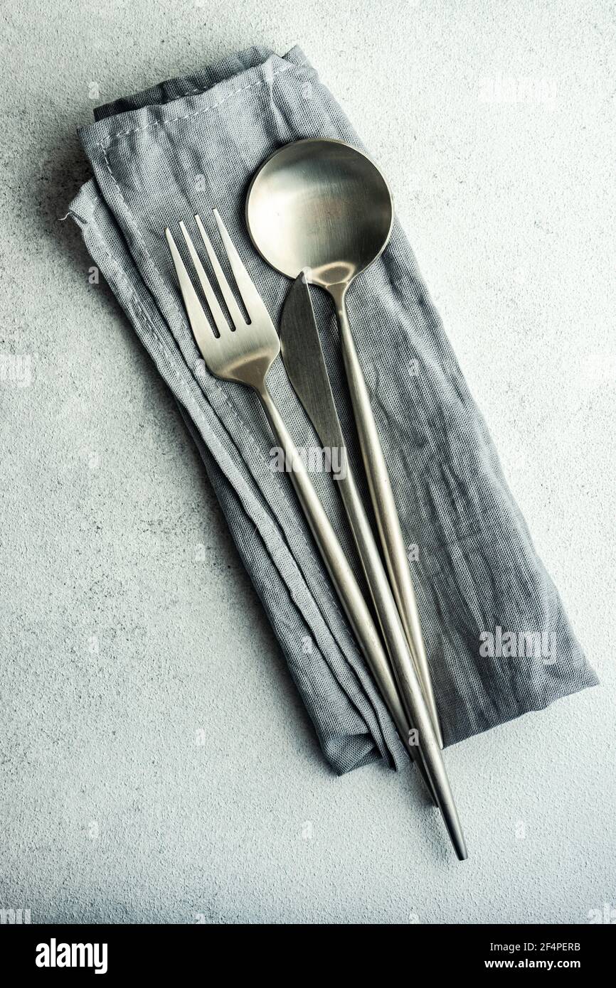 Modern cutlery on stone background Stock Photo - Alamy