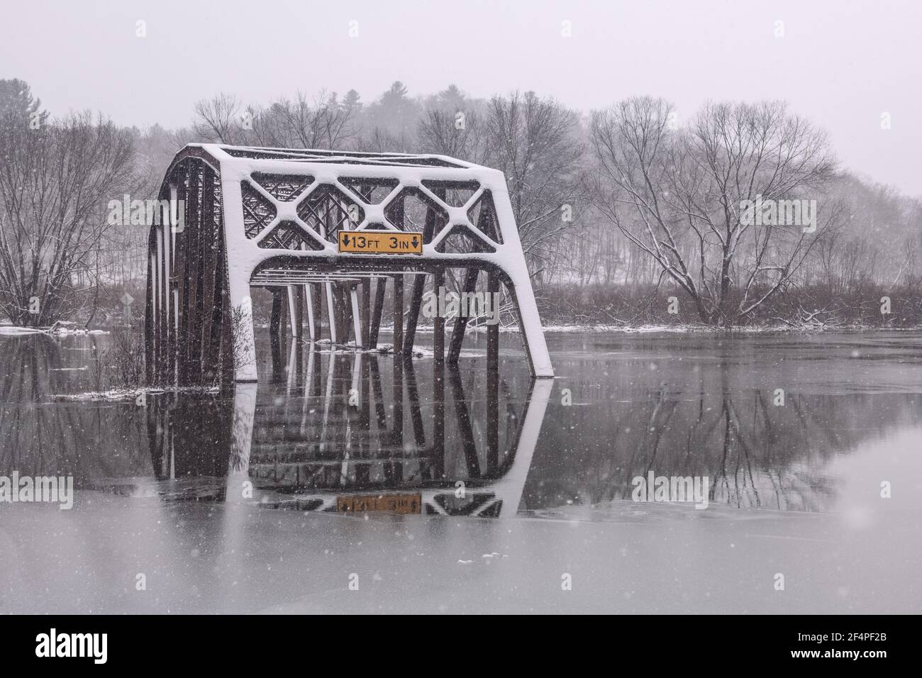 Flooded Bridge Reflected in Snowy Winter Scene Stock Photo - Alamy