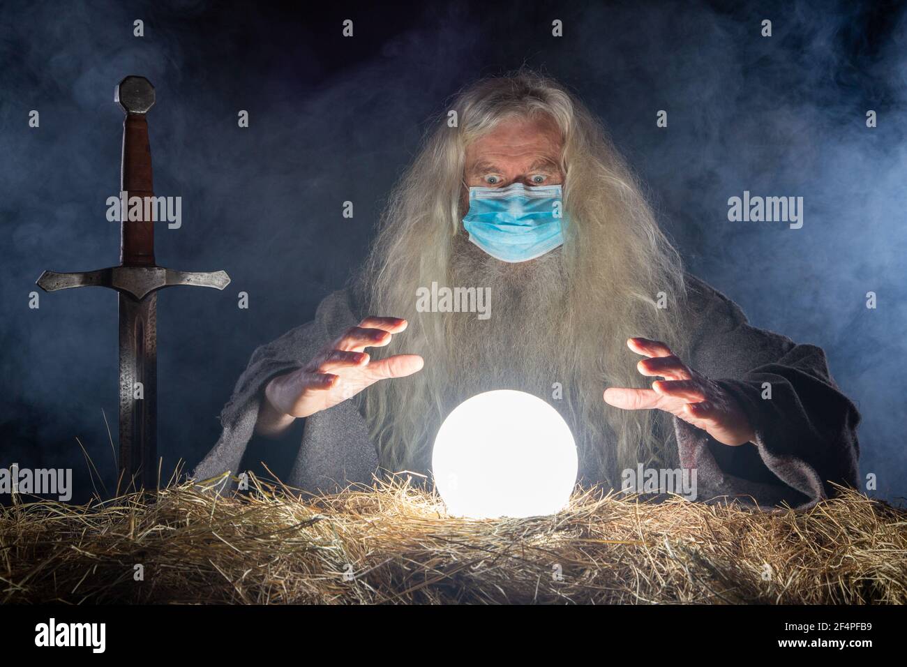 THE WIZARD WITH CORONA MASK LOOKS INTO THE CRYSTAL BALL TO PREDICT THE ...