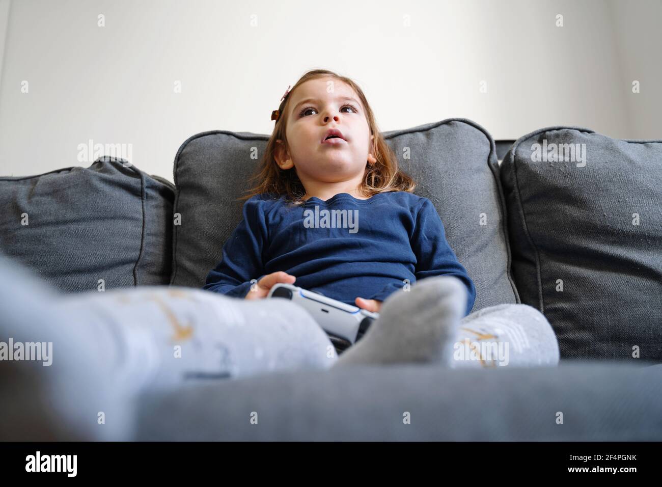 Small child playing video games with gamepad on console. Modern kids ...