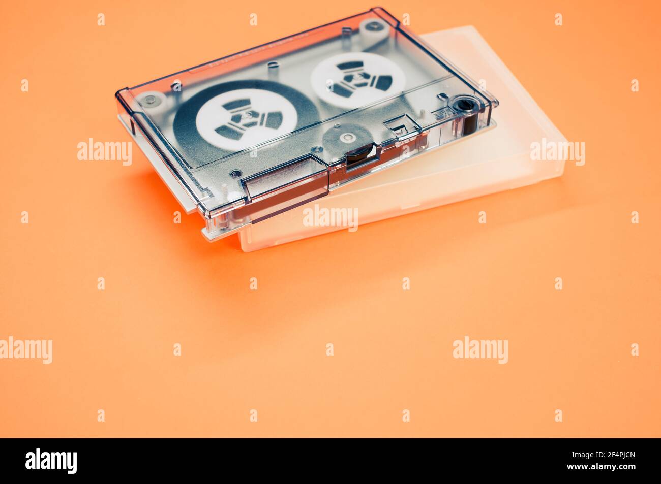Cassette tape with a case on an orange background Stock Photo - Alamy