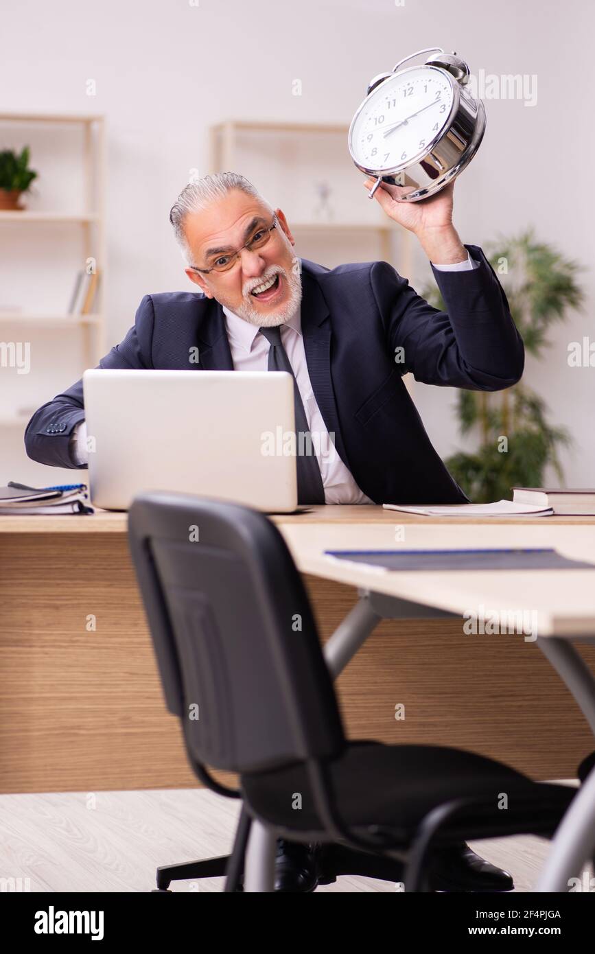 Old businessman employer in time management concept Stock Photo - Alamy