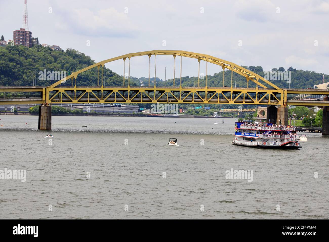 A river cruise boat in Monongahela River under Fort Pitt Bridge with ...
